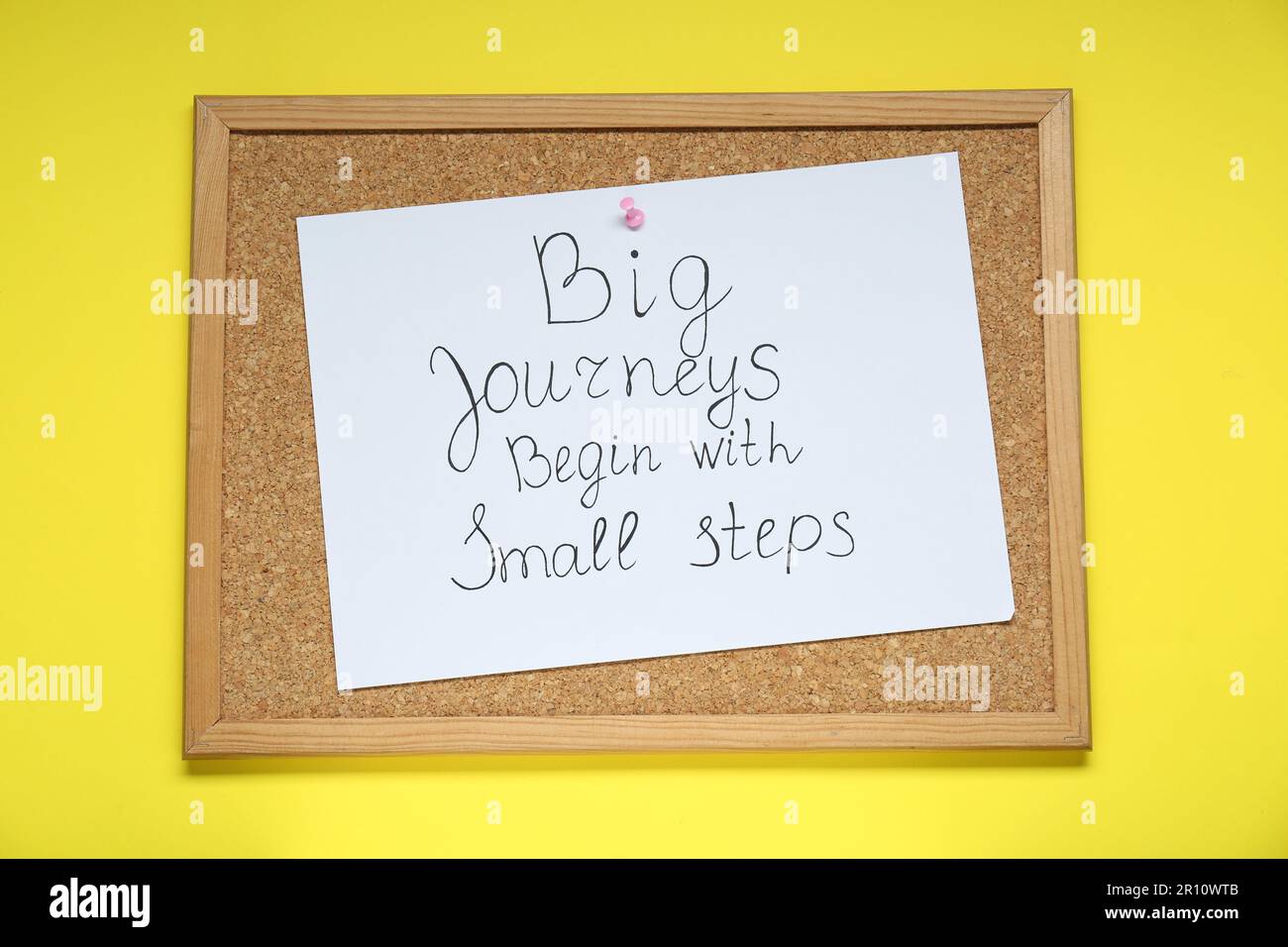 Corkboard with pinned message Big Journeys Begin With Small Steps on ...