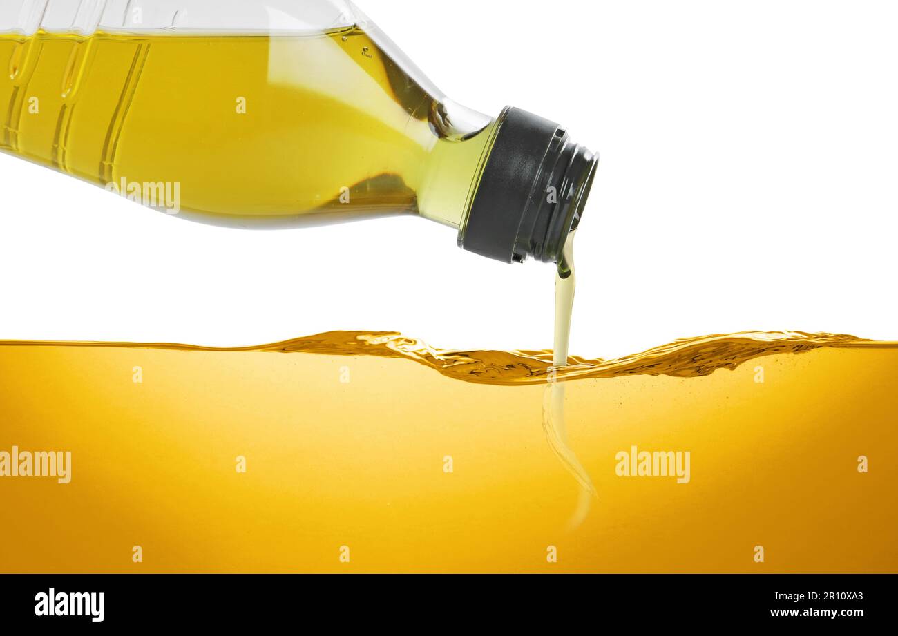Pouring cooking oil from bottle against white background Stock Photo ...