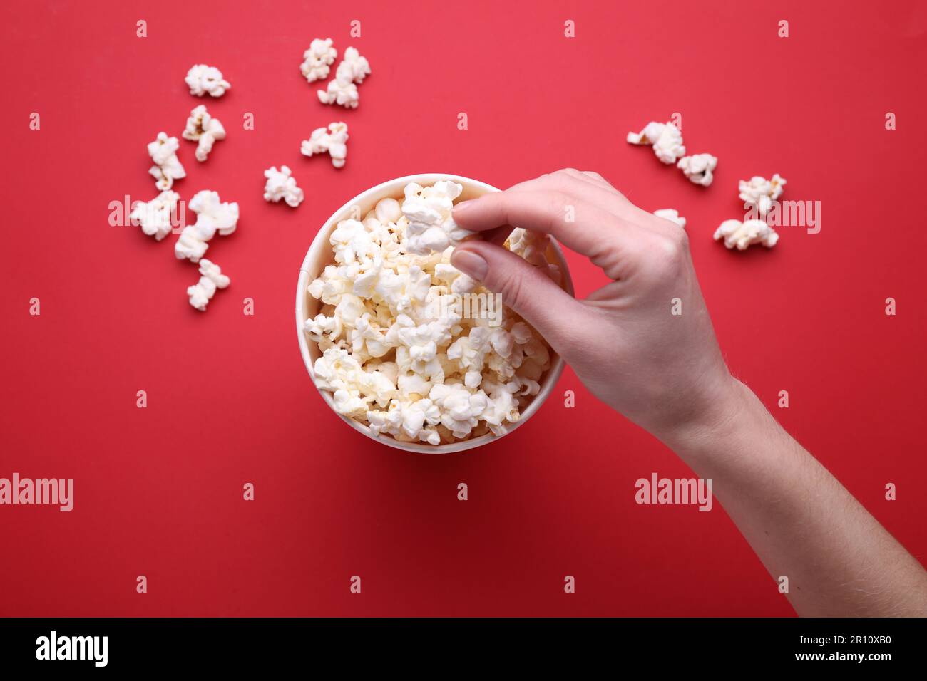 Woman taking delicious popcorn hi-res stock photography and images - Alamy