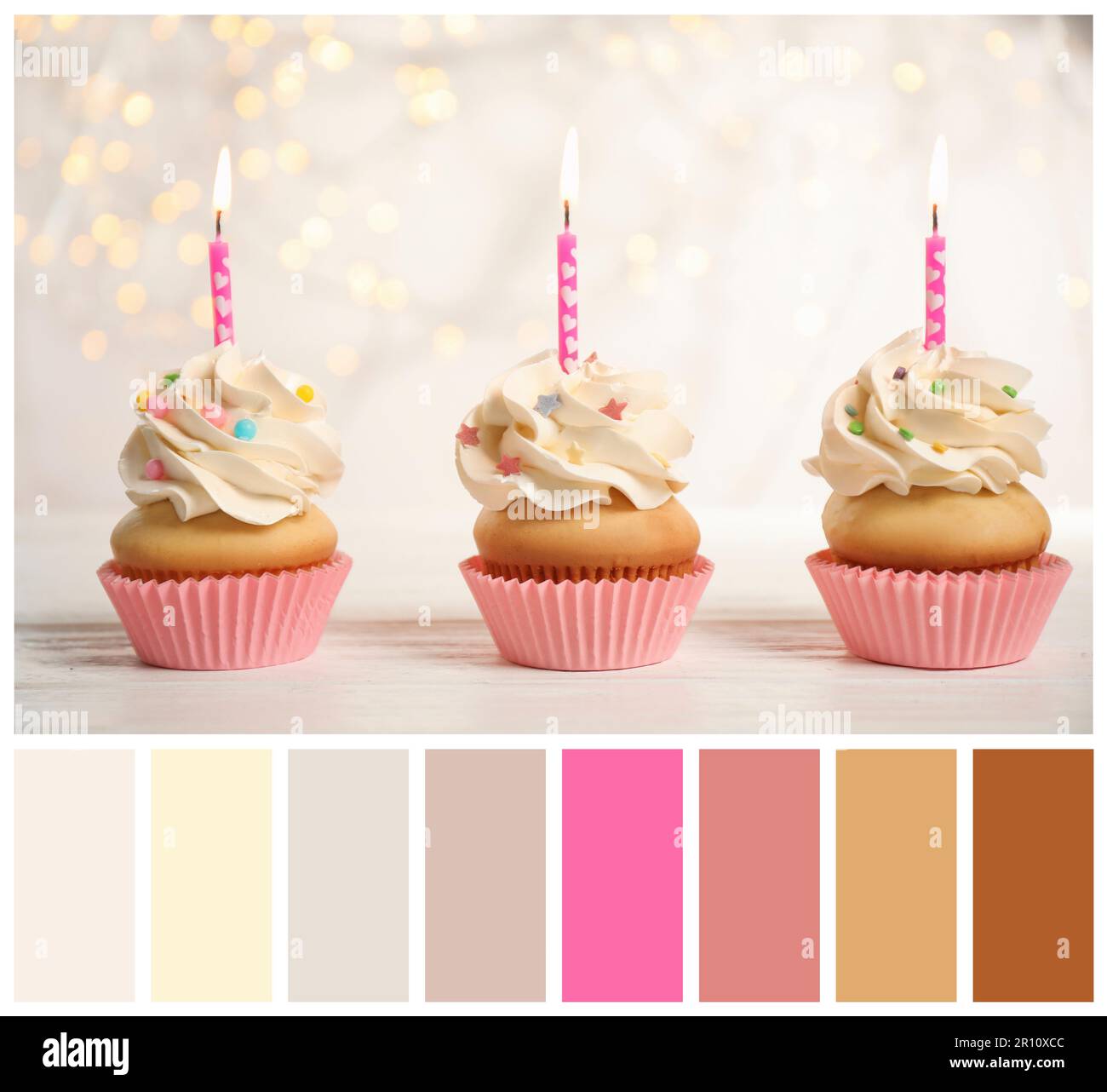 Birthday cupcakes with candles on white wooden table against blurred ...