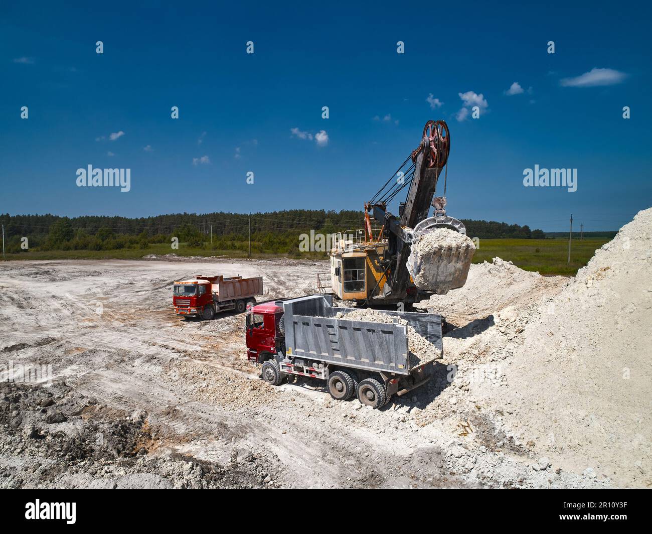 shovel mining excavator loads chalk into tipper truck in quarry Stock ...