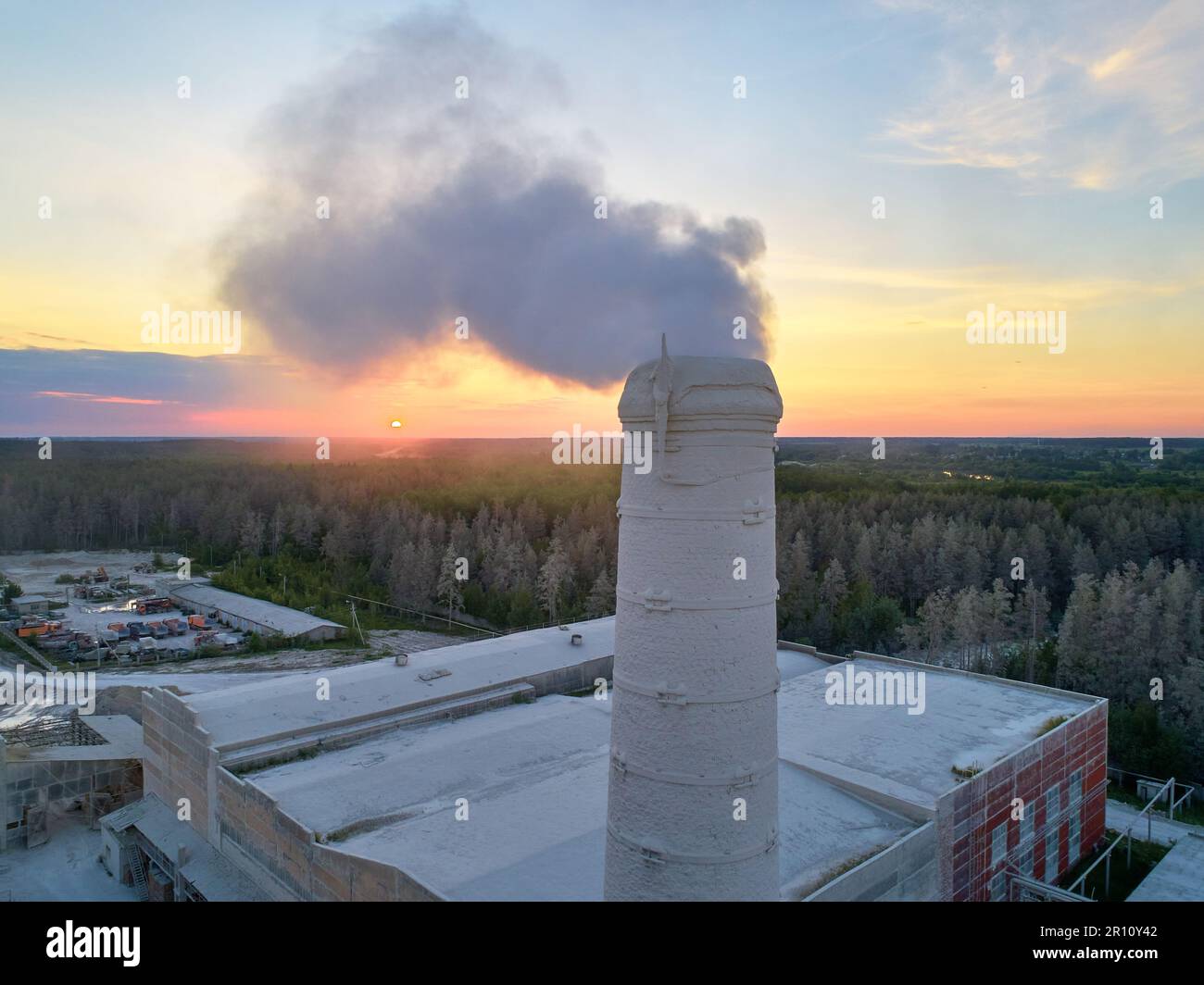Steam rises up from brick chimney on production plant roof Stock Photo ...