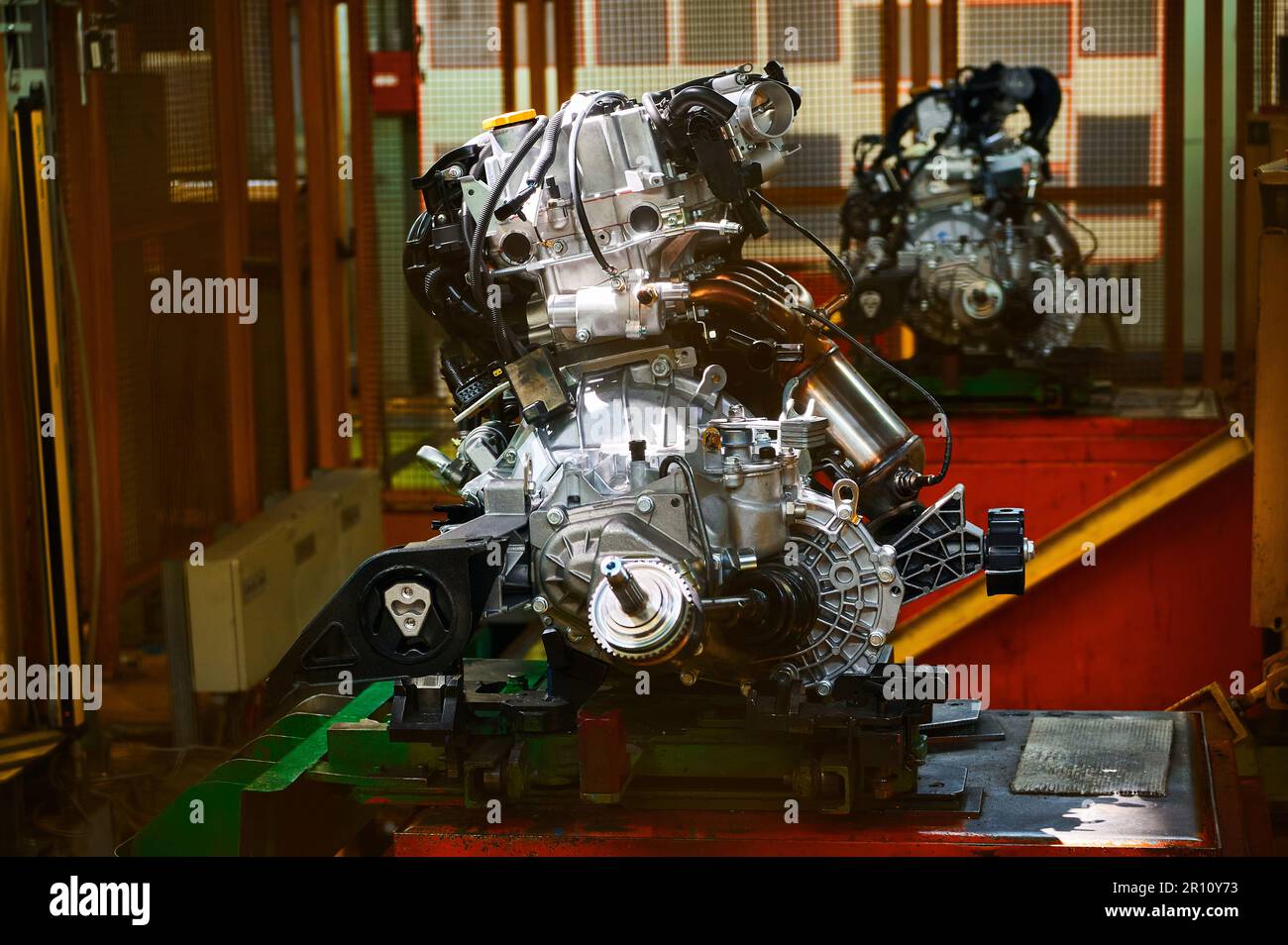 Engine installing in car compartment in assembling workshop Stock Photo ...
