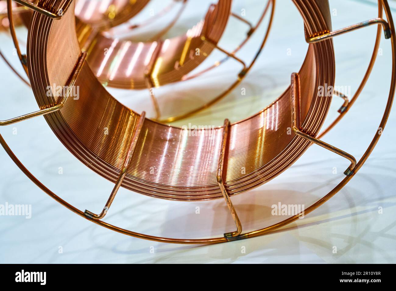 Sparkling brass welding cable reel on table in warehouse Stock Photo ...