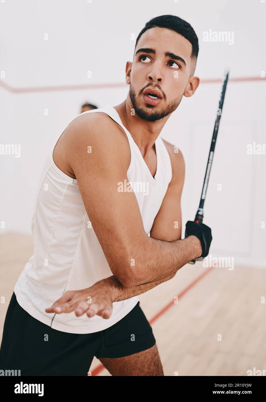 Thats why they call him a pro. a young man playing a game of squash ...