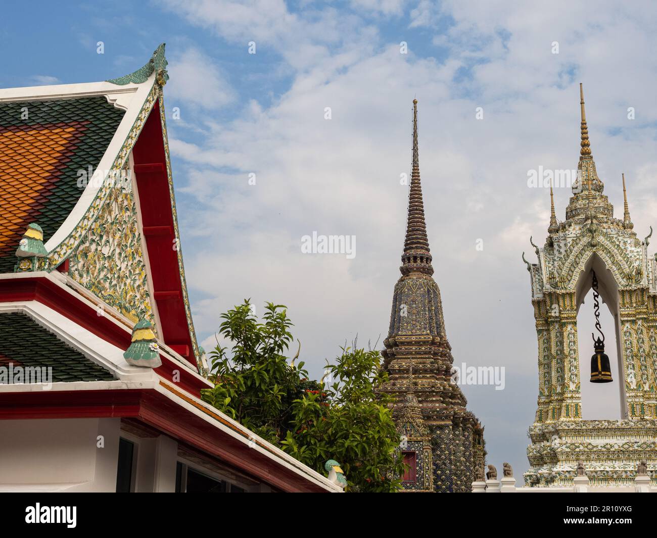 A roof with colorful patterns, a tower with gold ornaments and a bell ...