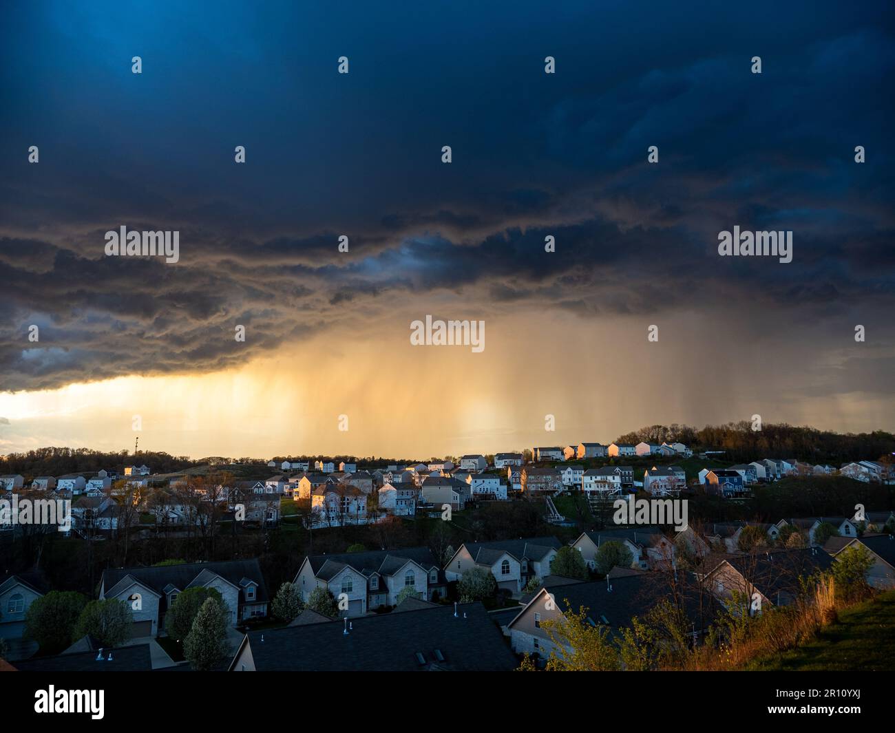 The contrast of sun-rays and dark clouds creates a dramatic scene over ...