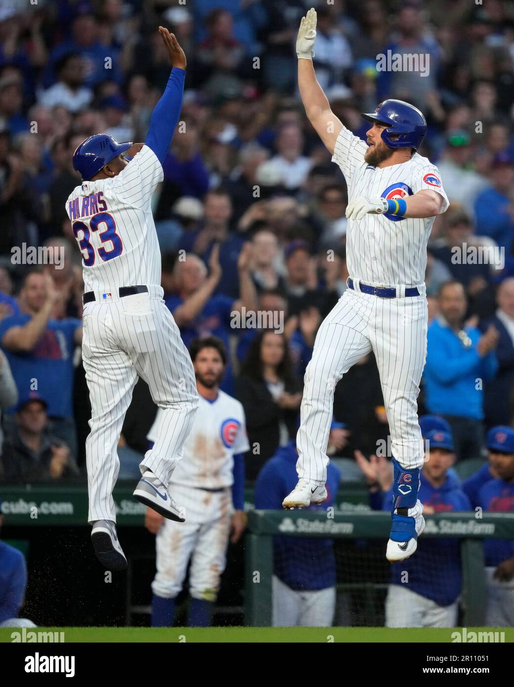 Chicago Cubs' Patrick Wisdom, right, celebrates with third base coach ...