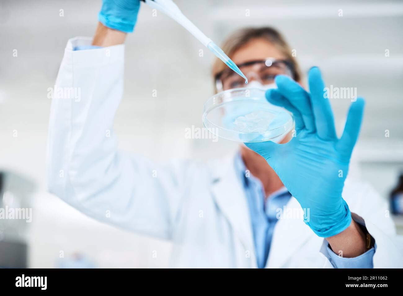 Identifying and observing something new. a scientist using a dropper ...