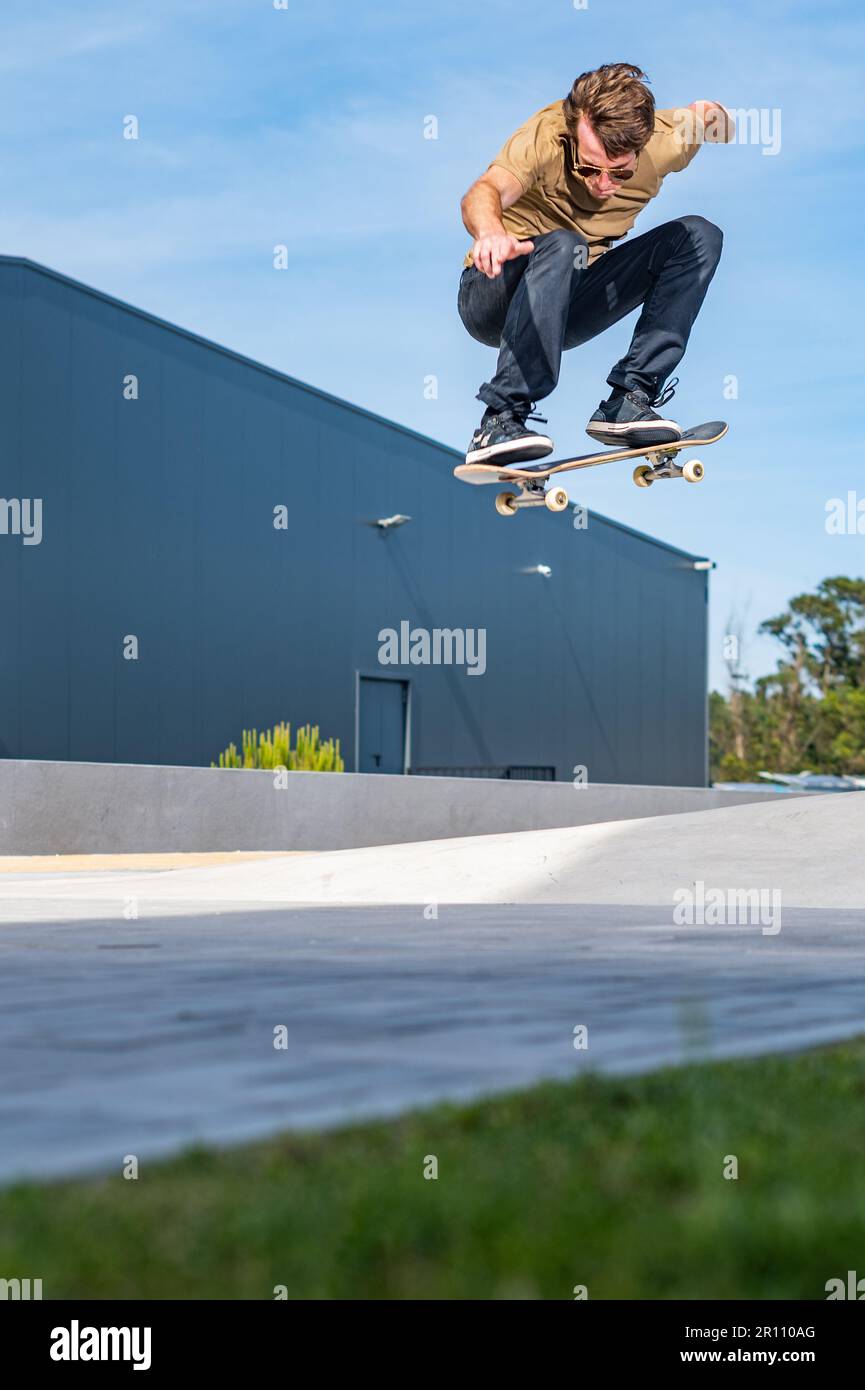 Skateboarder doing ollie trick on a urban scene Stock Photo - Alamy