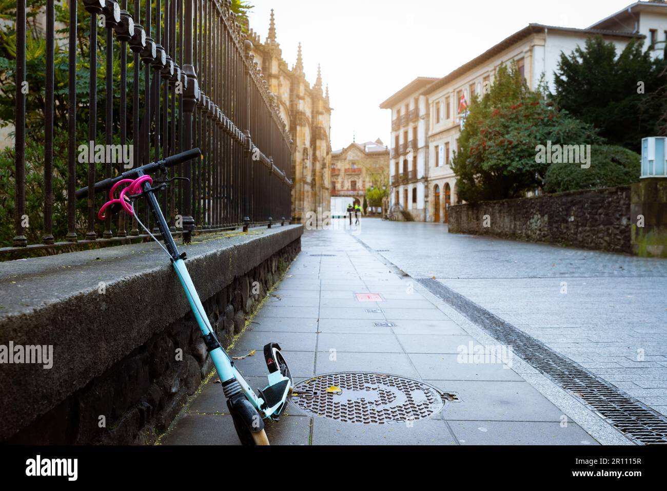 Electric scooter bike lean on concrete wall beside street in Europe ...
