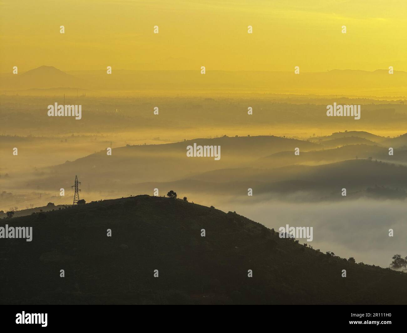 Magical view of Da Lat city, Vietnam. The pine forests are shrouded in ...