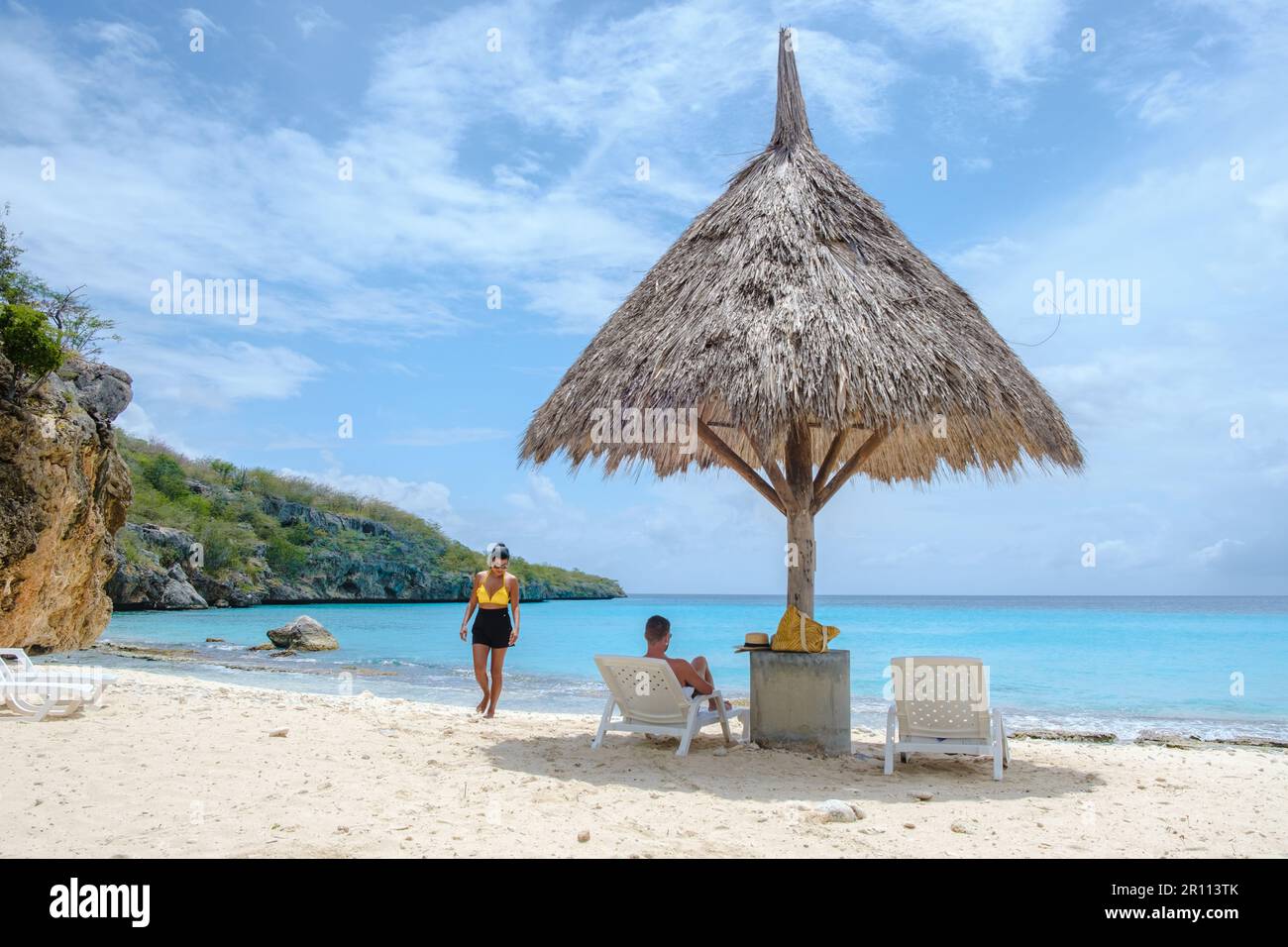 A couple of men and women on vacation in Curacao, Cas Abao Beach Playa Cas Abao Caribbean island ...