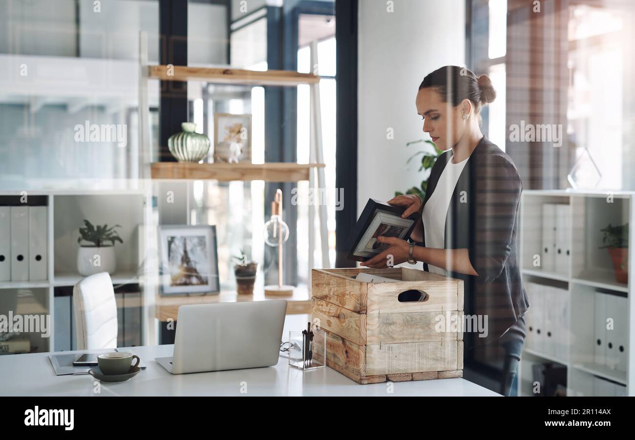 First day at the office. an attractive young businesswoman arranging ...