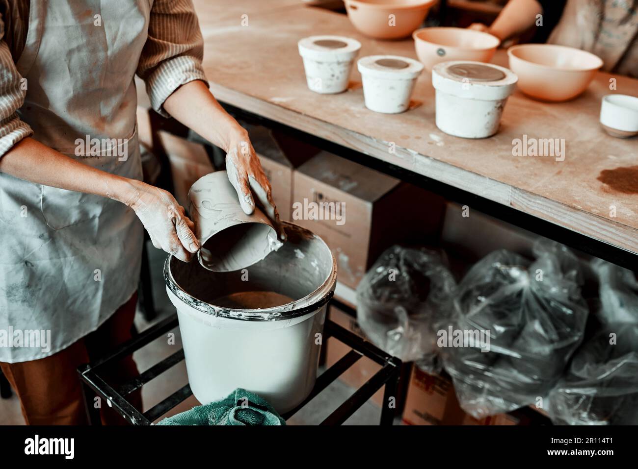 Lets get busy. an unrecognizable artisan working in a pottery workshop ...