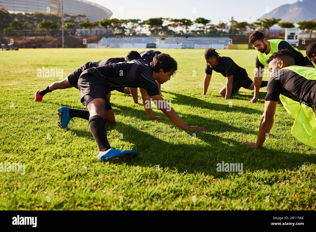 Feeling the stretch. a diverse group of sportsmen stretching before a ...