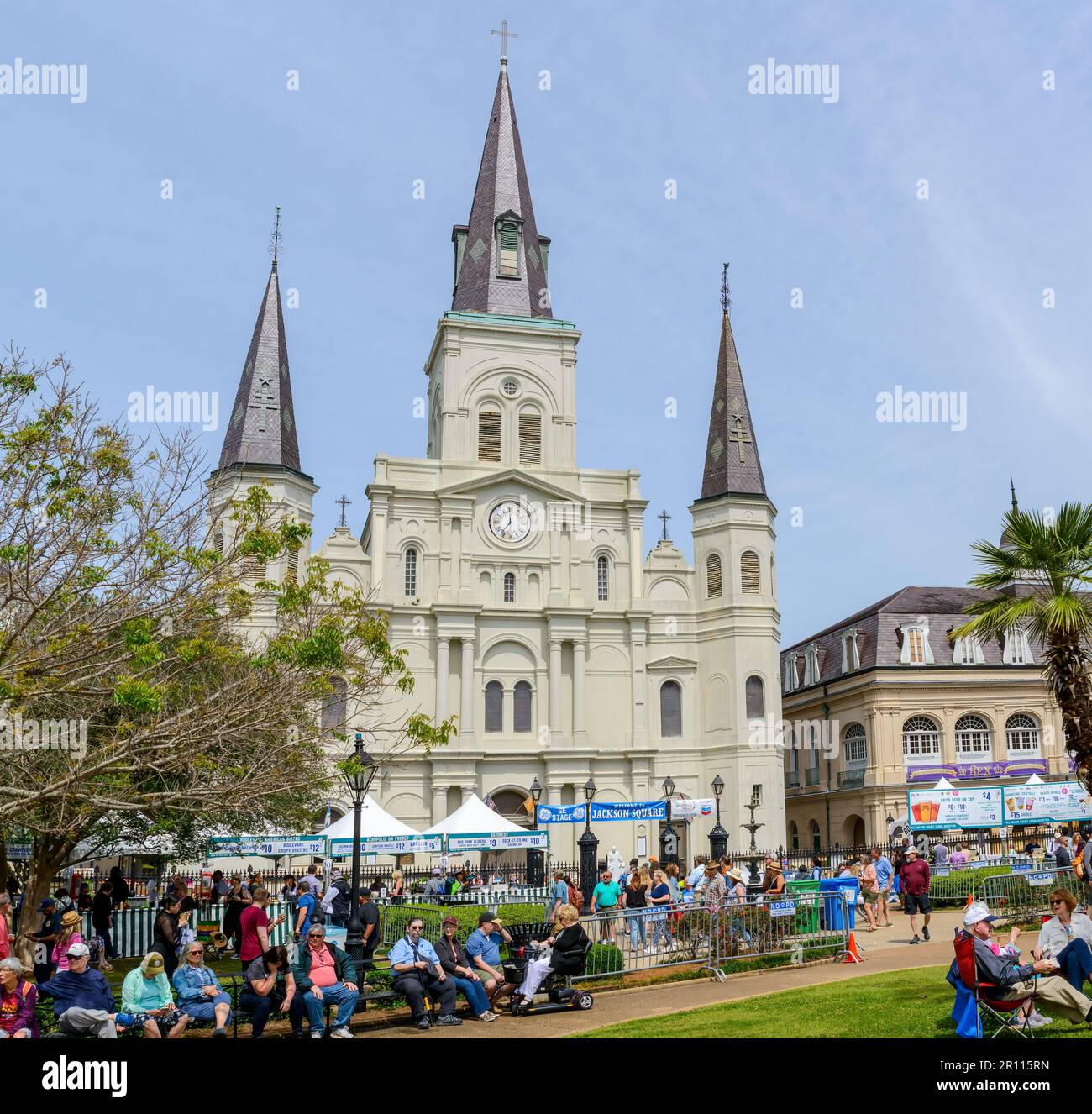 NEW ORLEANS, LA, USA - APRIL 16, 2023: Crowd and food booths in Jackson Square with St. Louis ...