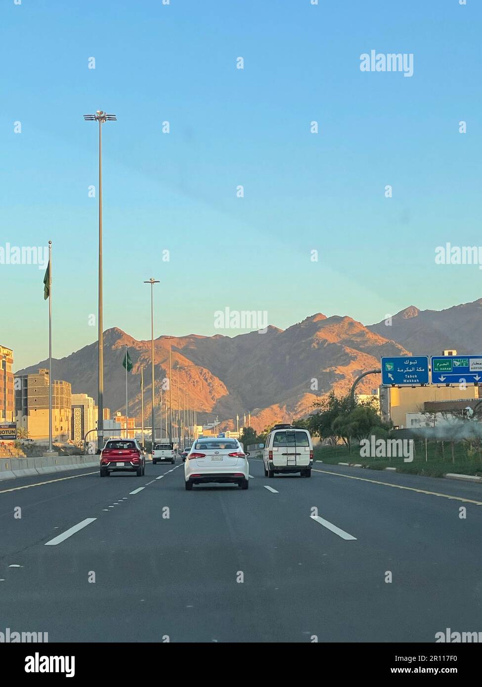 The cars traveling along a scenic highway dotted with towering ...