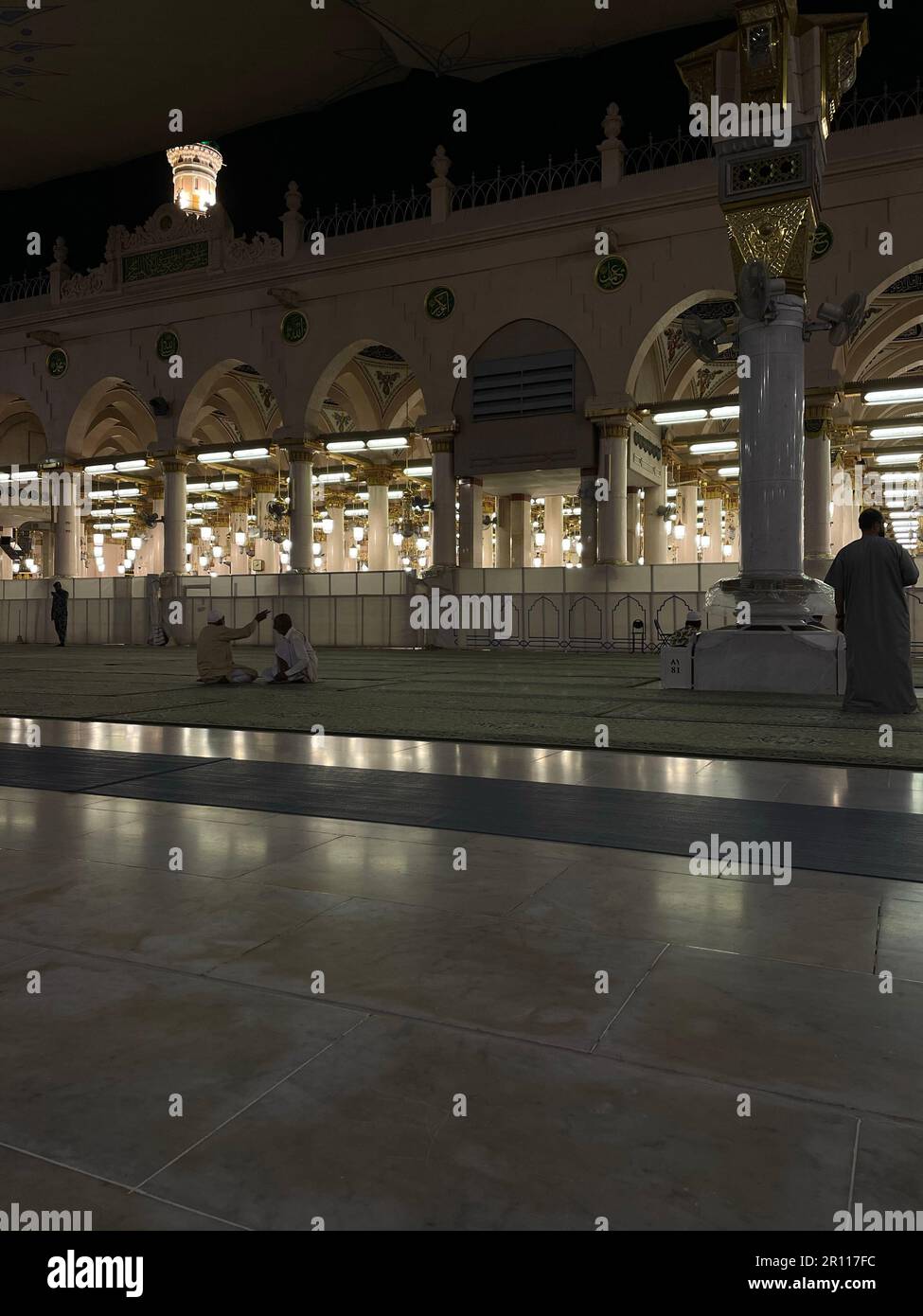 A stunning view of the Prophet's Mosque illuminated by bright lights at ...