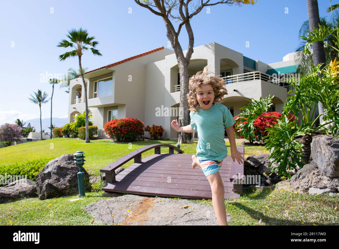 Excited kid boy running on backyard. Sporty child boy runner running in ...