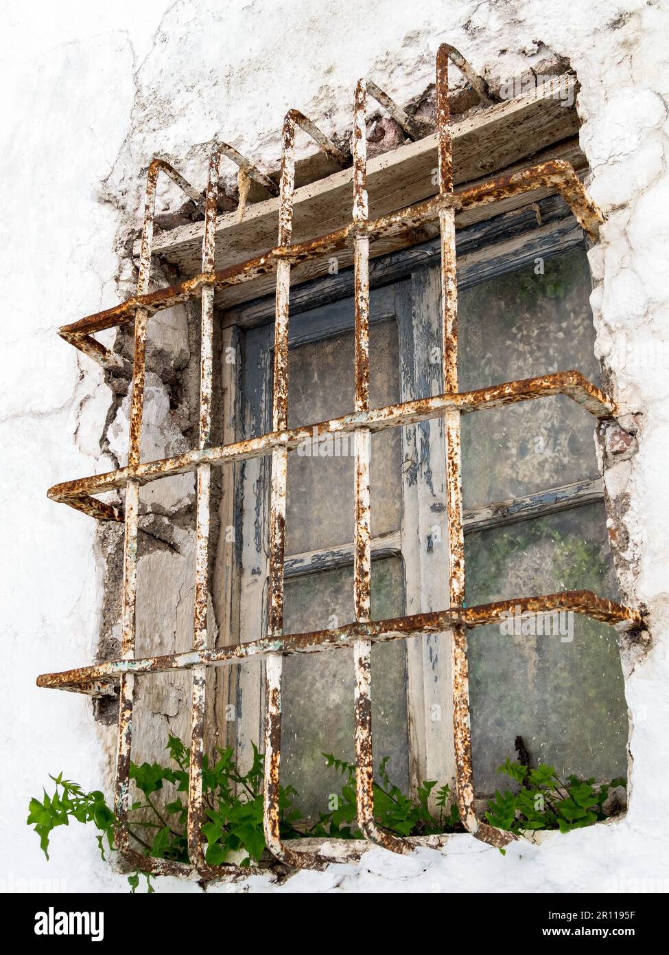 Rusting bars across a window of a derelict building in Casares Spain ...