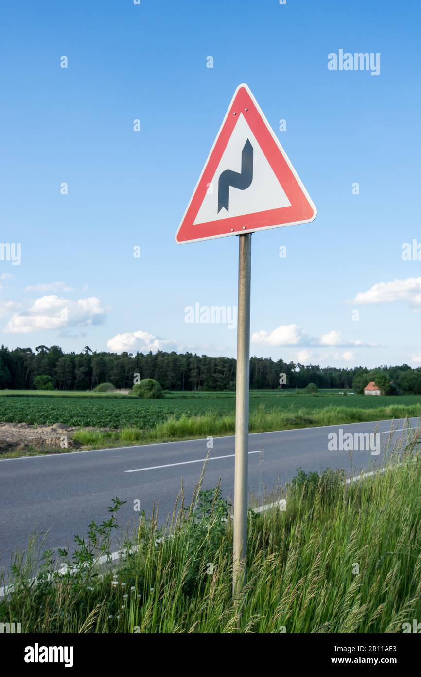 Traffic sign warning for a winding road Stock Photo - Alamy