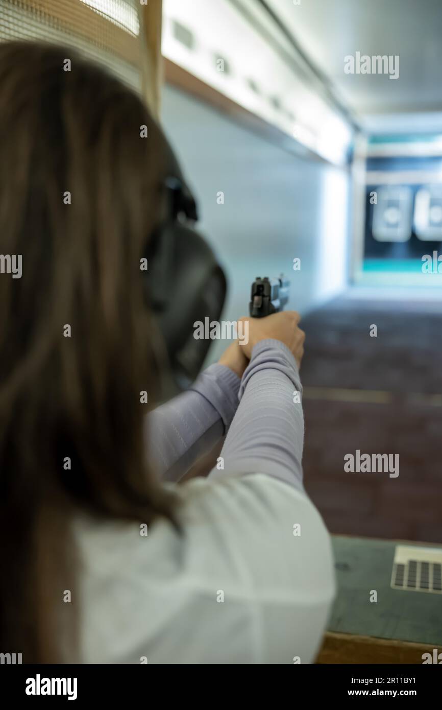 Woman Shooting with a Gun in Shooting Range with Target in Switzerland ...