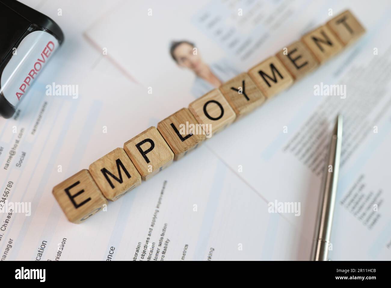 Word employment collected with wooden cubes, pen and stamp approved on ...