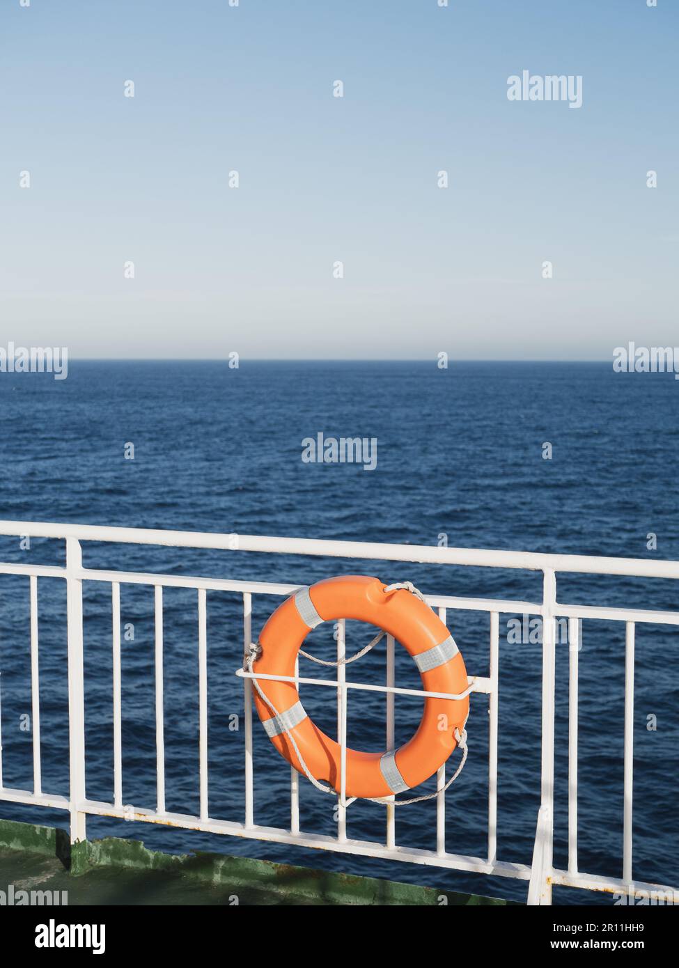 Life belt at the ship railing and views to empty ocean Stock Photo - Alamy