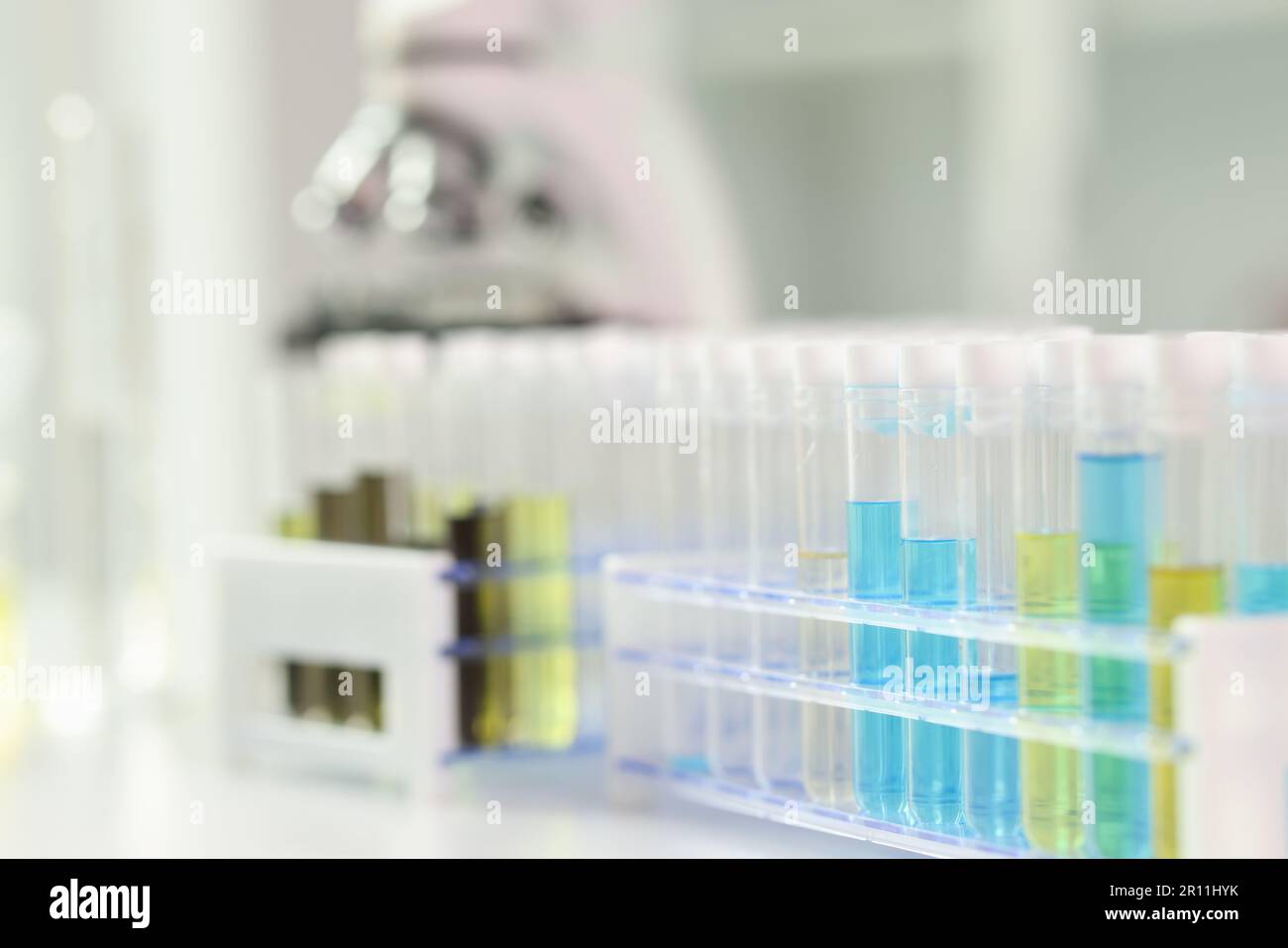 Test tubes with colourful liquid, microscope on background Stock Photo ...