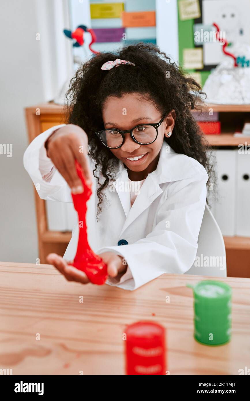 Science, experiment and African child with slime learning, studying or ...