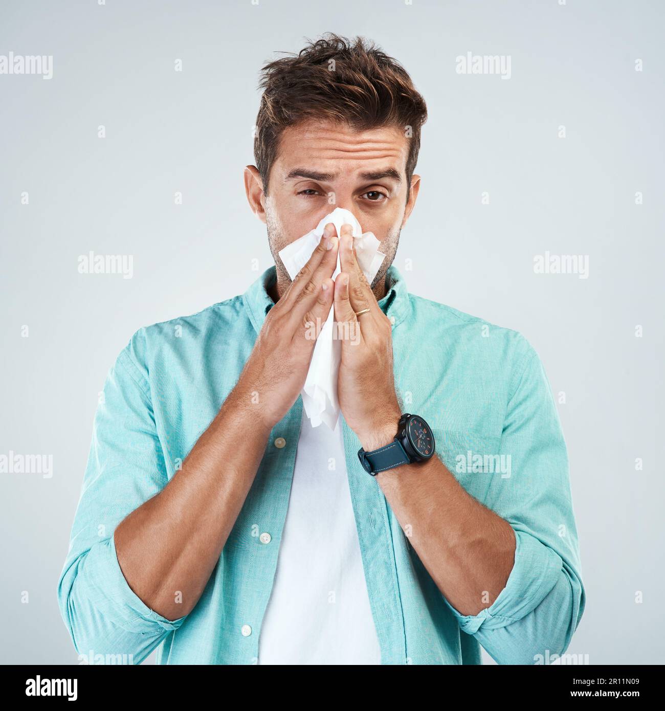 Sick, tissue and portrait of man blowing nose in studio with flu ...