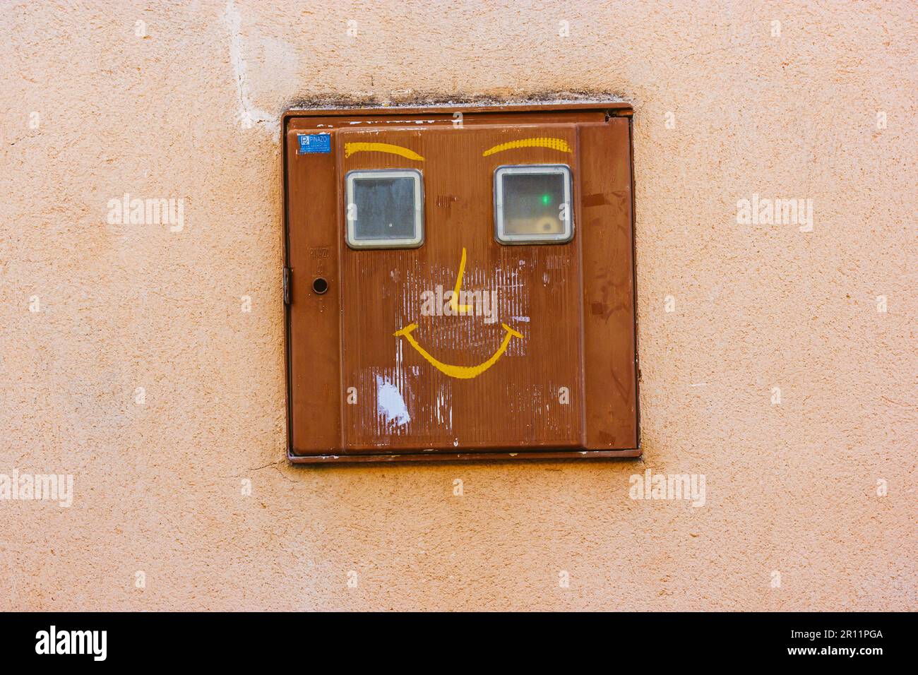 Industrial electrical junction box on the orange wall with a funny ...