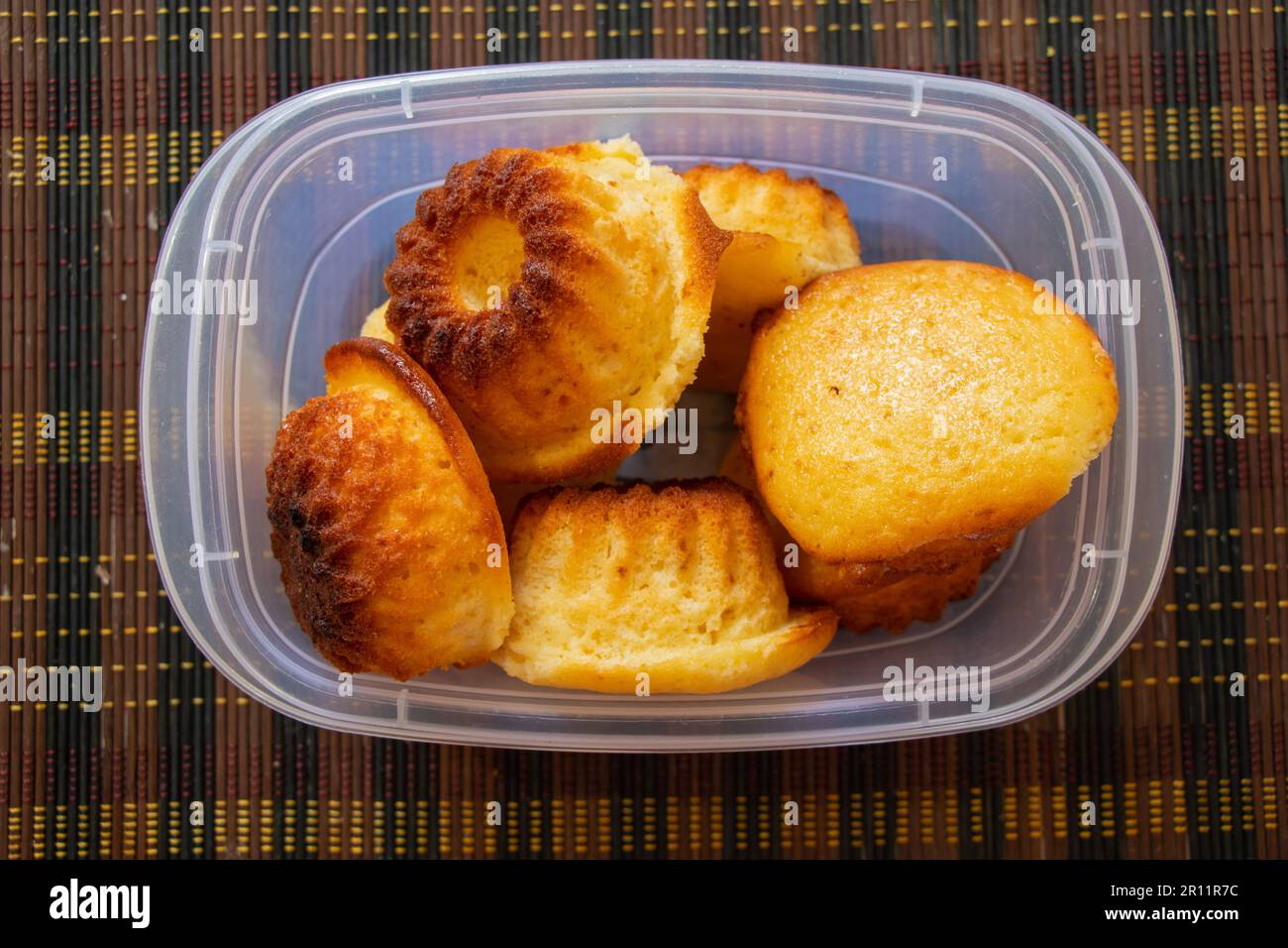 muffins in a plastic box on a table in the kitchen Stock Photo - Alamy