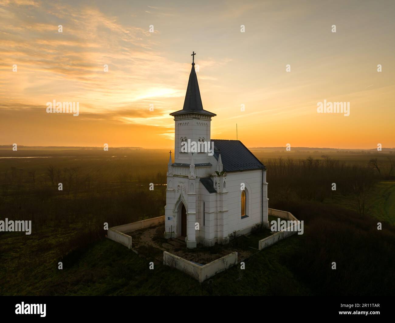 Small white chapel in alone in the fileds with scenic sunrise colored ...