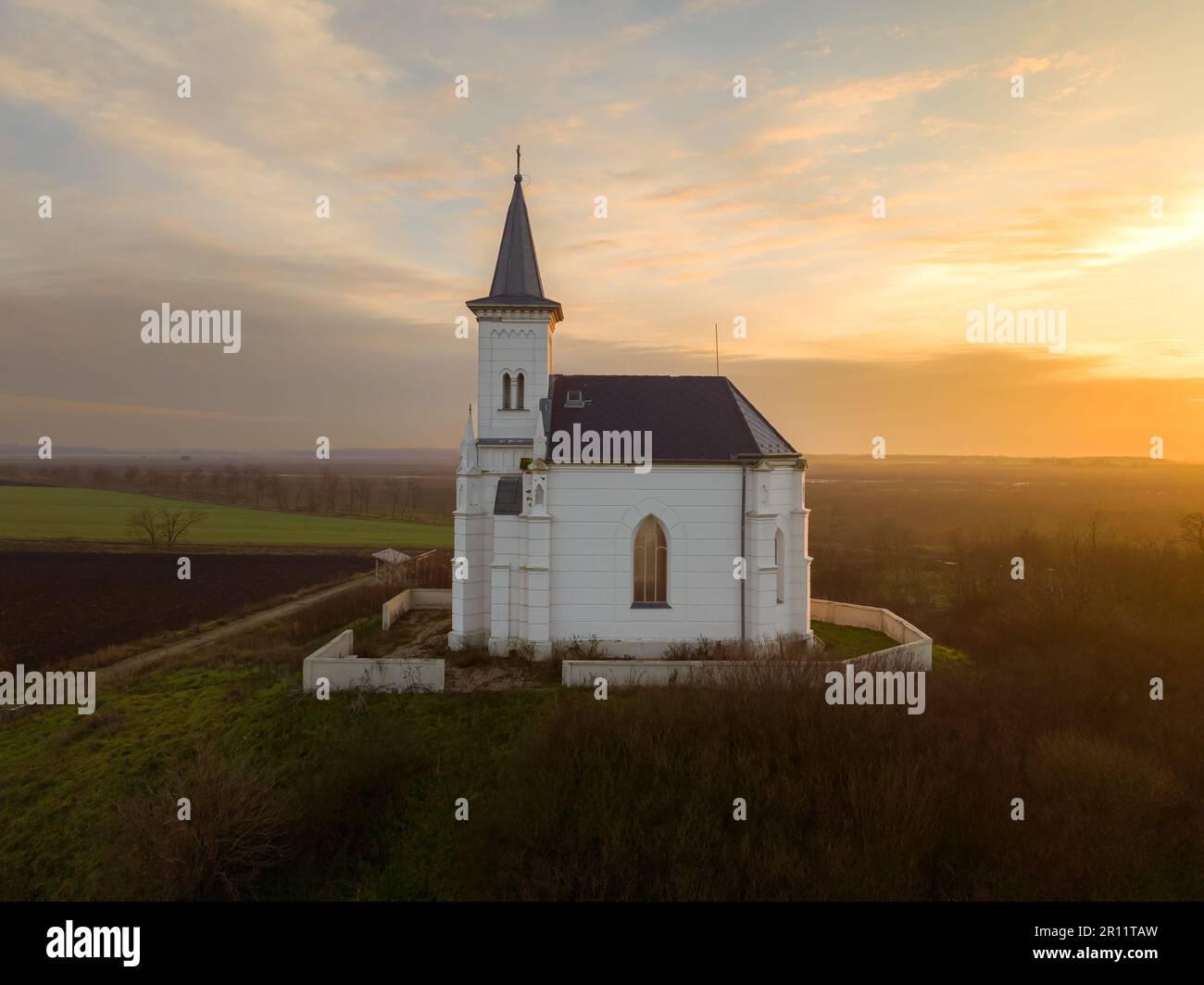 Small white chapel in alone in the fileds with scenic sunrise colored ...