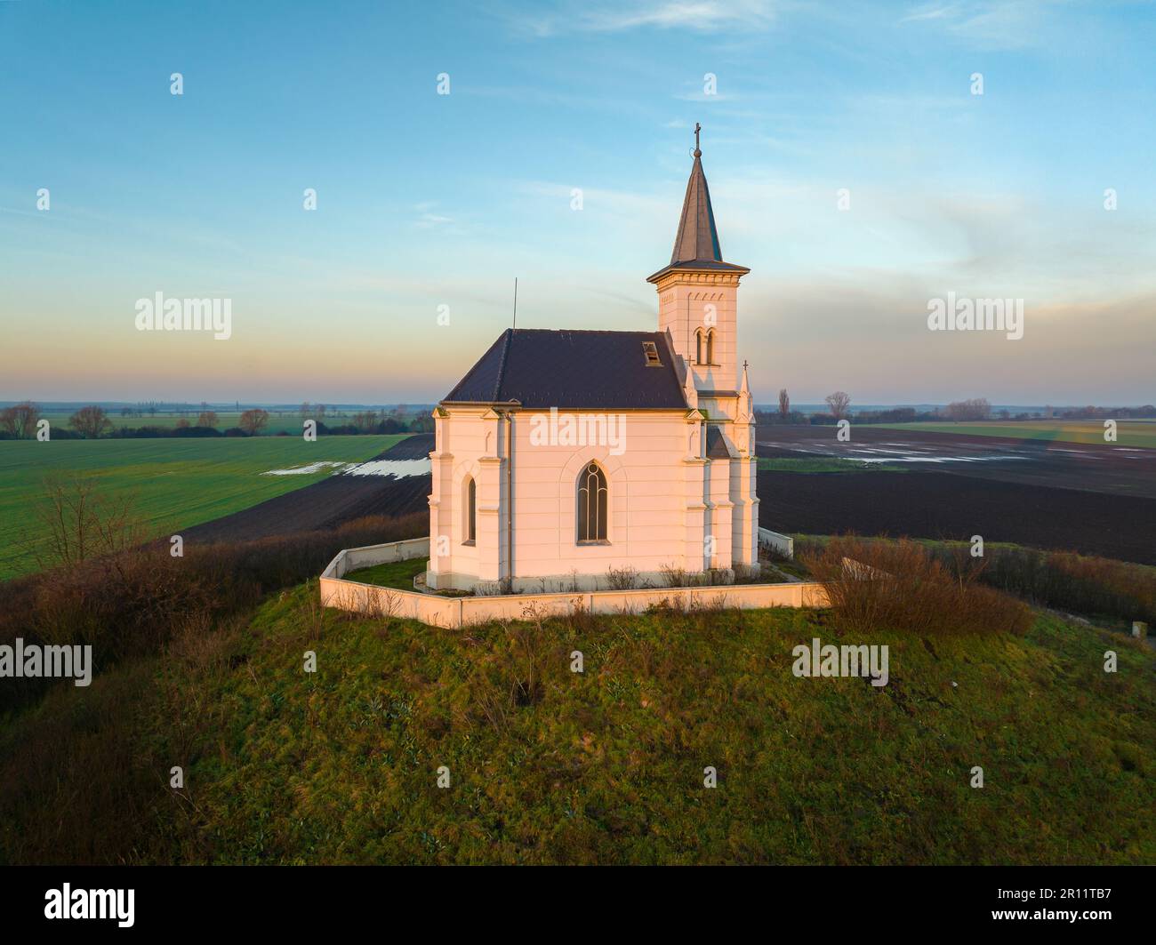 Small white chapel in alone in the fileds with scenic sunrise colored ...