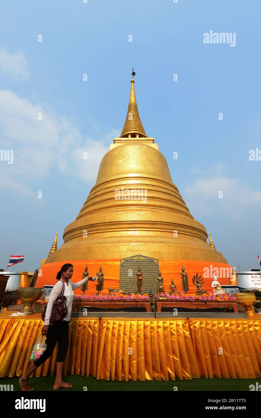 Prayers by the beautiful Golden pagoda on top of the Golden Mount in ...