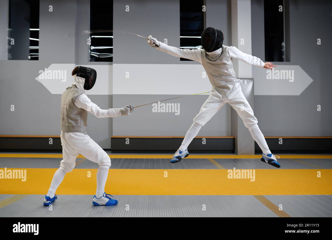 Two fencers sparring during training session in professional martial ...