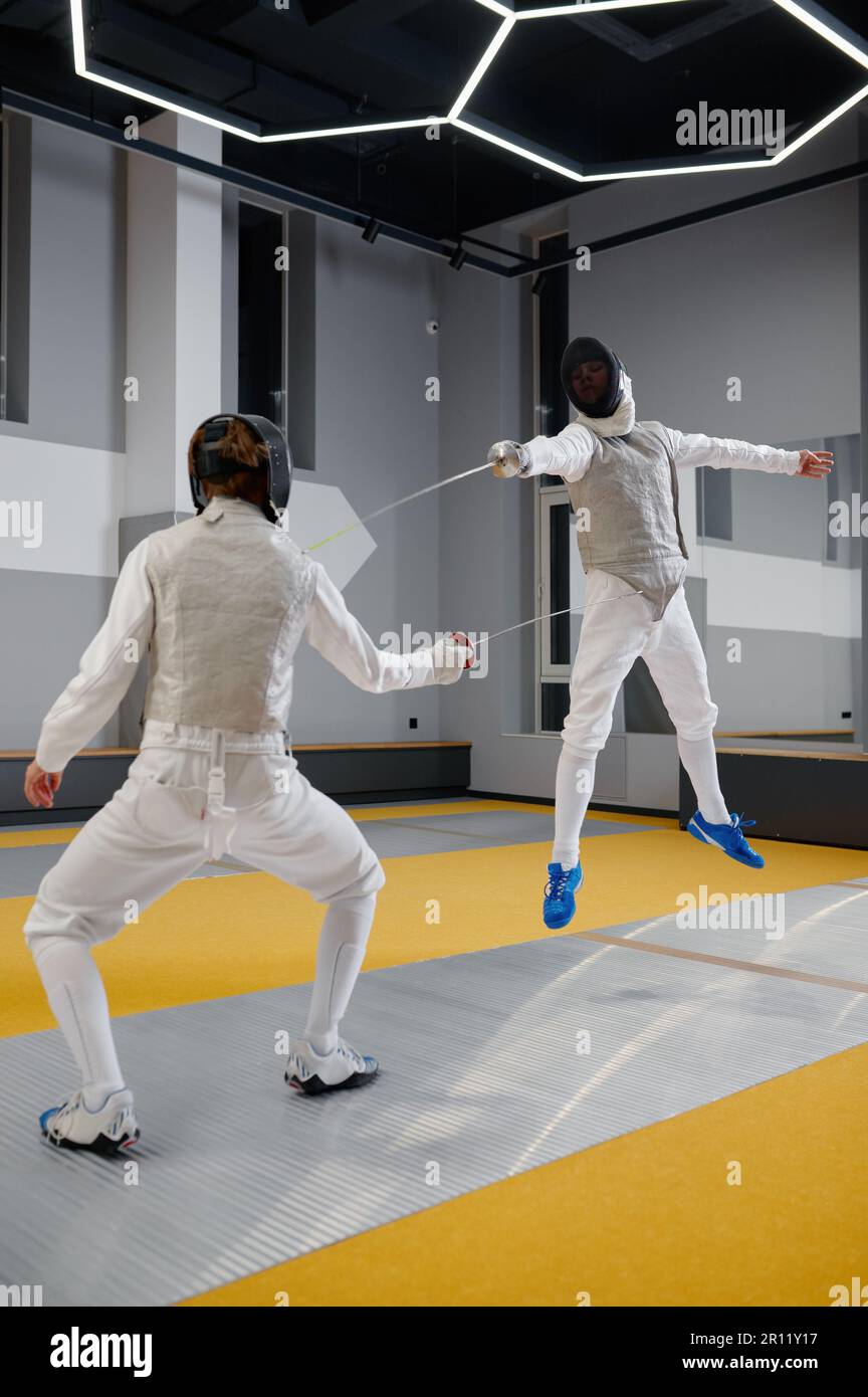 Two fencers sparring during training session in professional martial ...