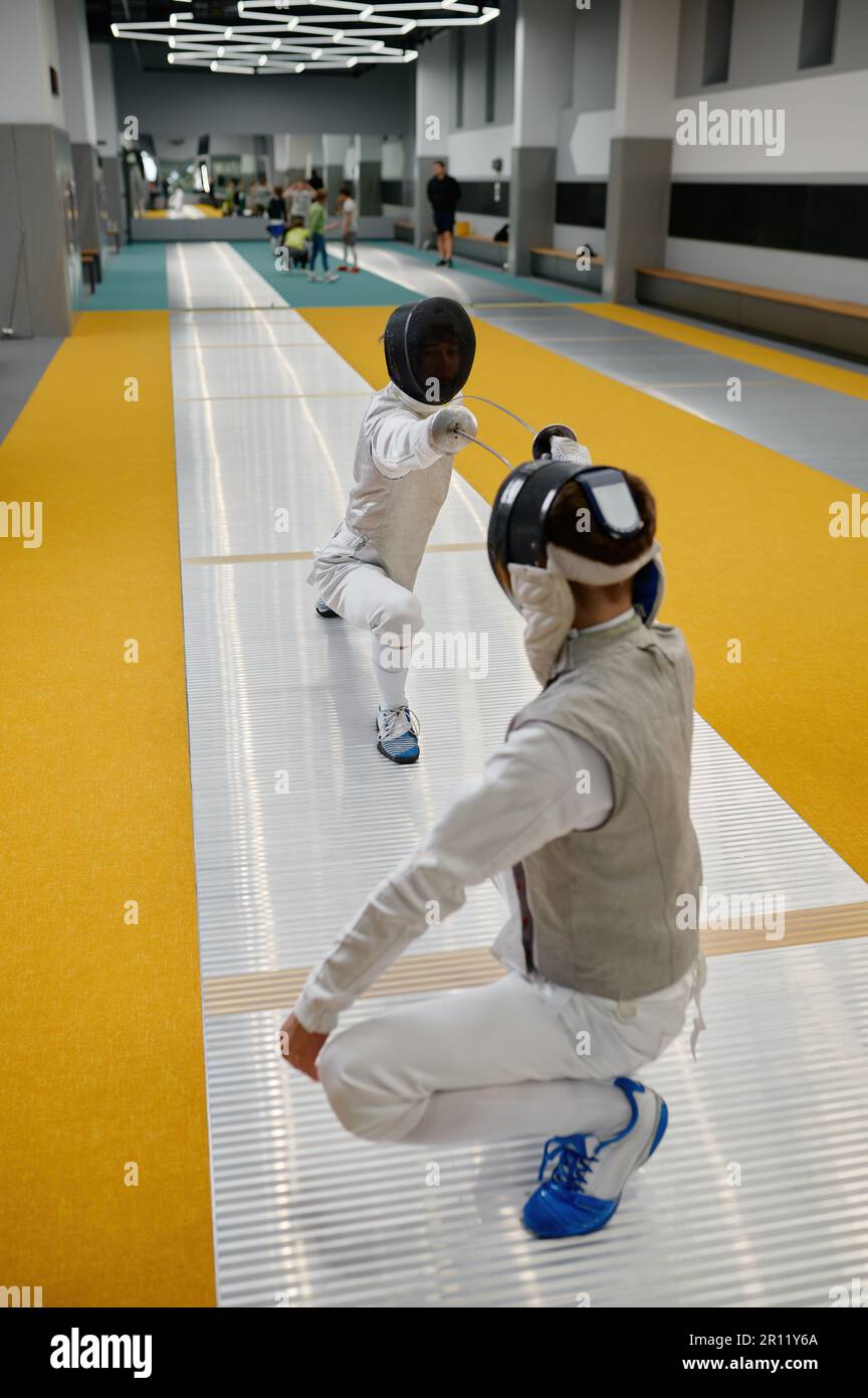 Duel of fencers during fencing match, training lesson at martial art ...