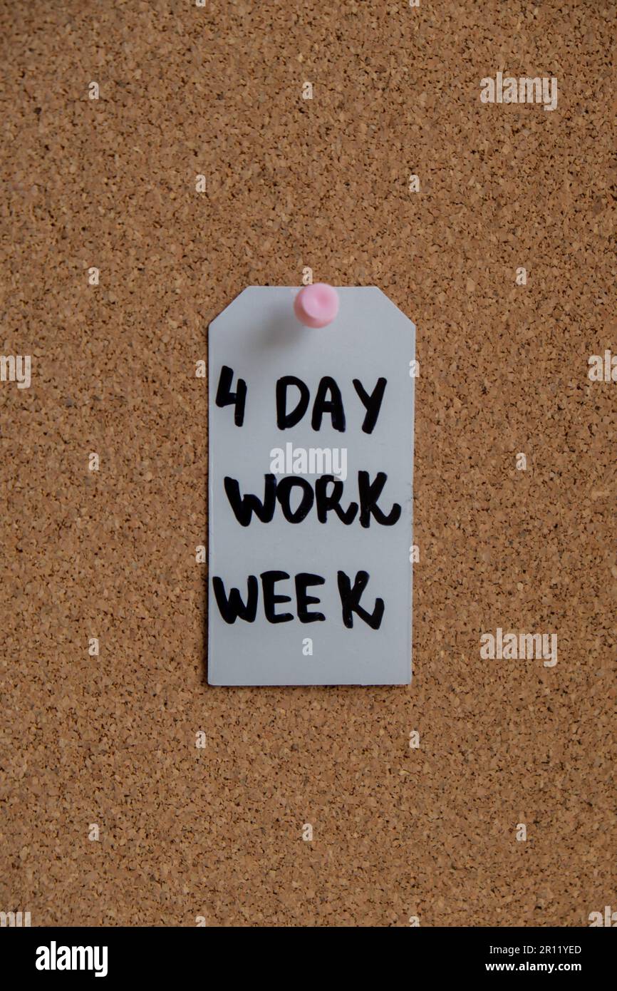 4 day work week text on paper note pinned to desk four day working week ...