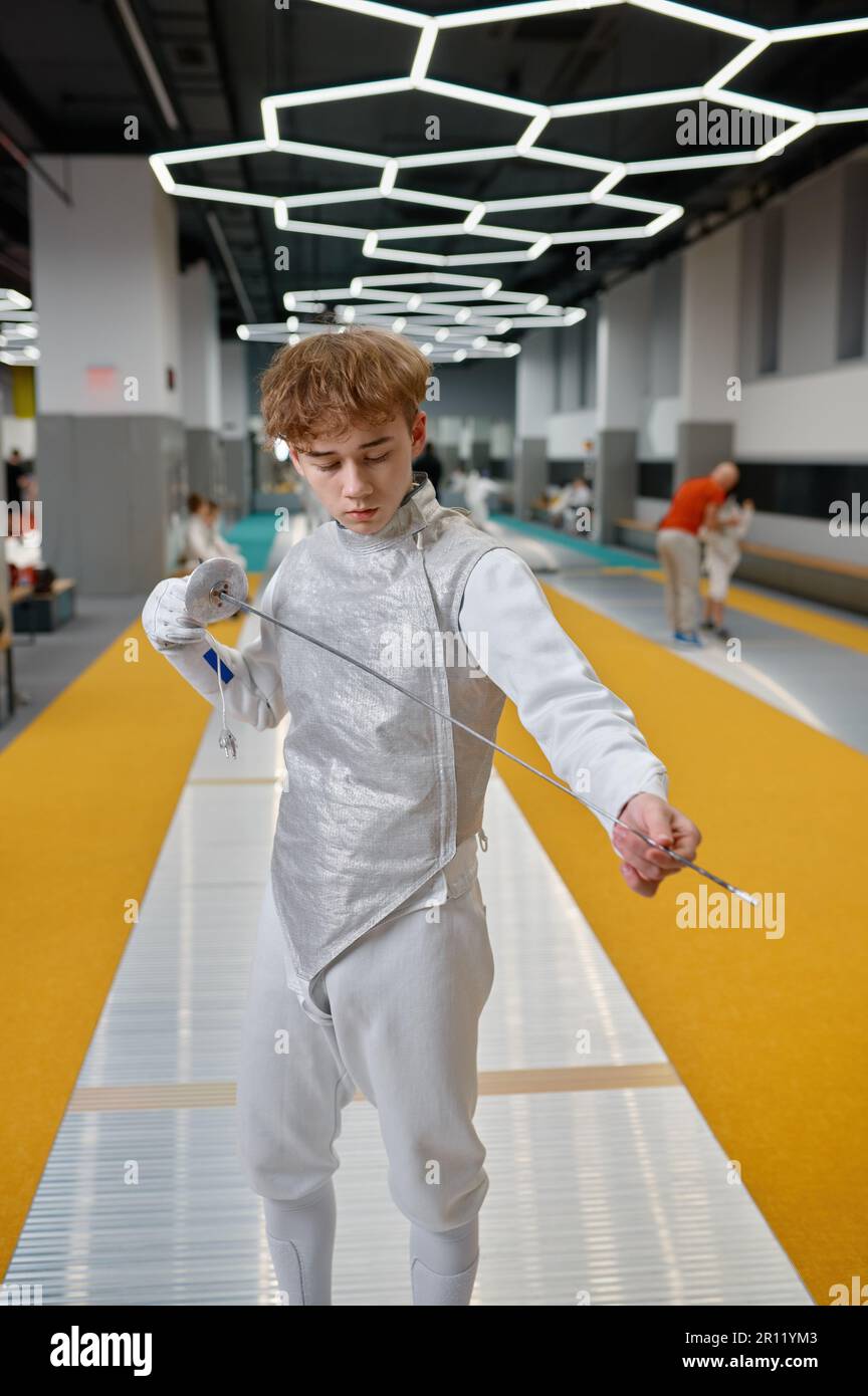 Portrait of confident teenage boy fencer with sharp sword Stock Photo ...
