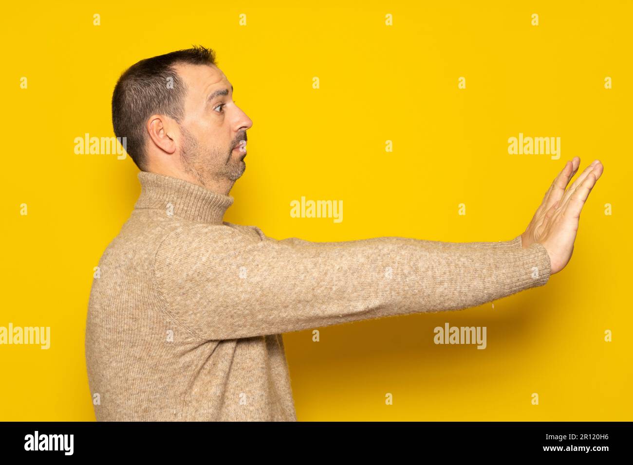 Side view of a scared man standing with a scared or worried face ...