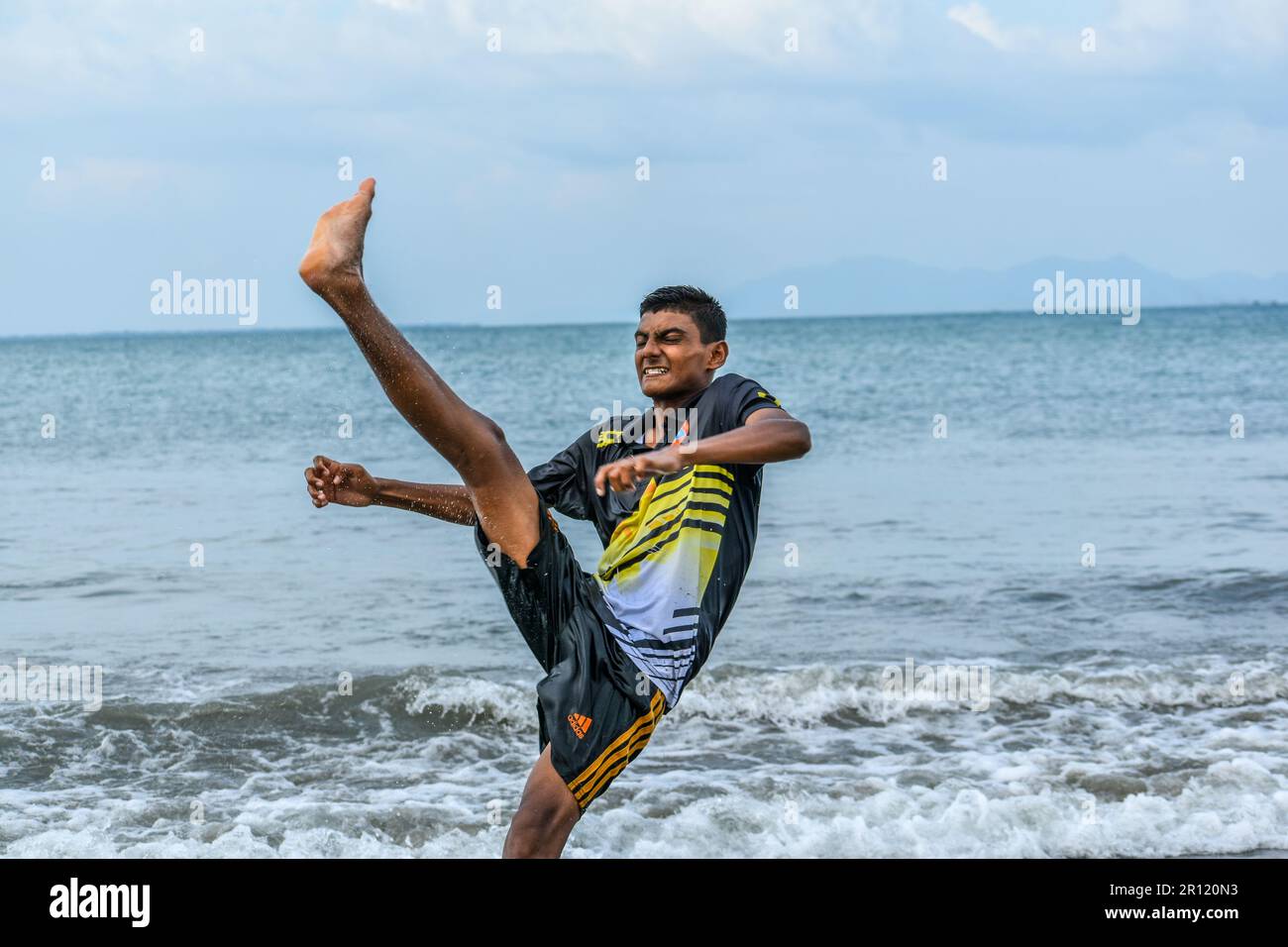 Bengali boy performing a bicycle kick on seawater at beach Stock Photo ...