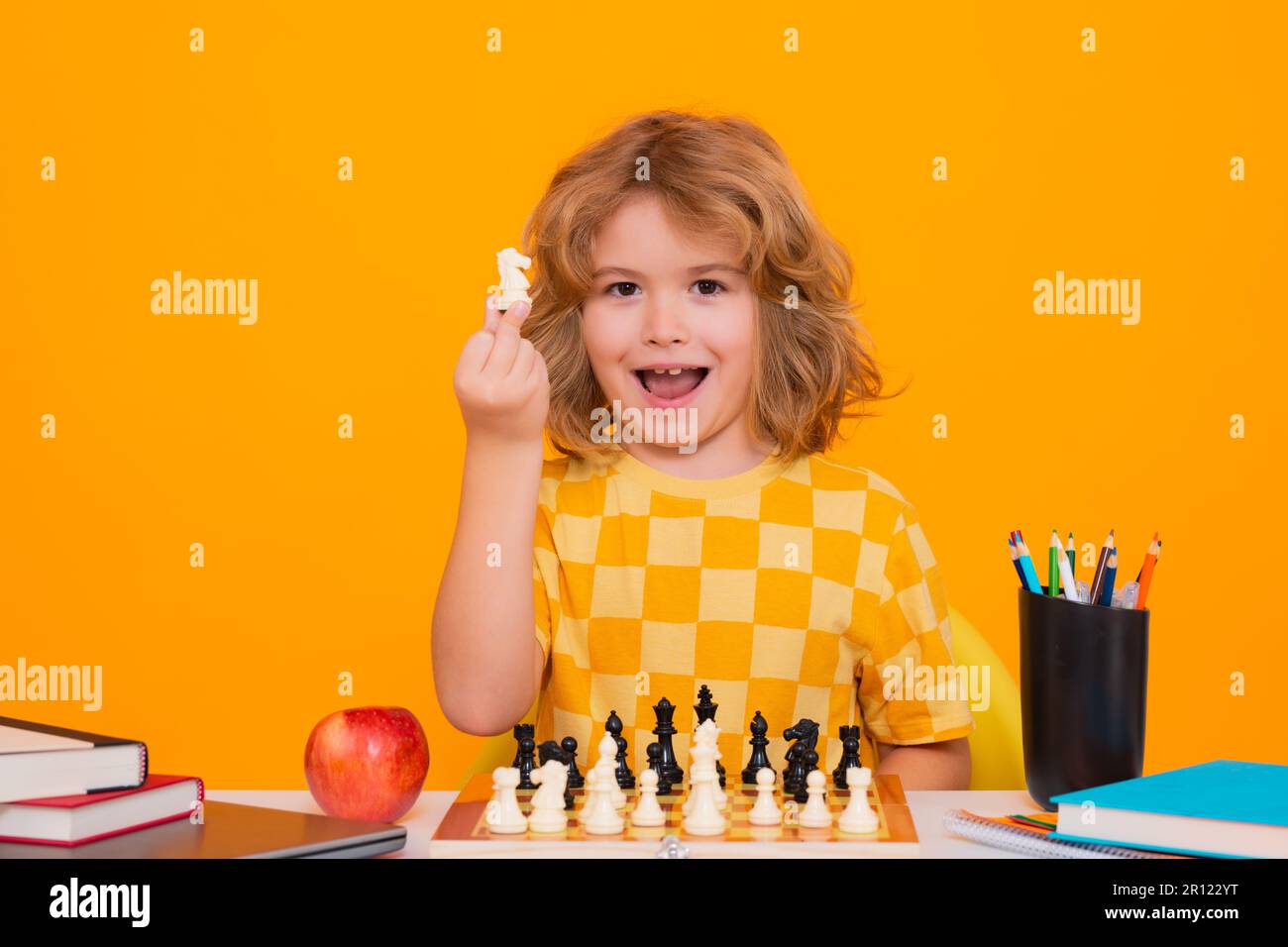 Child play chess on isolated background. Kid thinking about chess. The ...