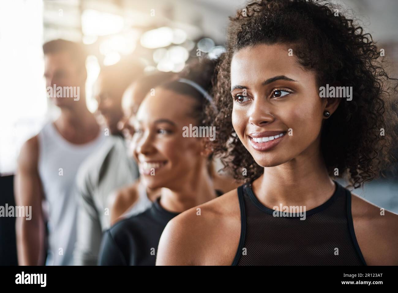 Standing together in the name of fitness. a group of young people ...