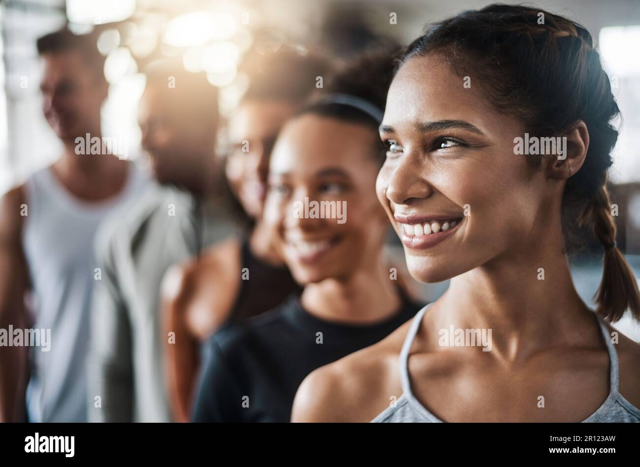 Ready to take their fitness challenge. a group of young people standing ...
