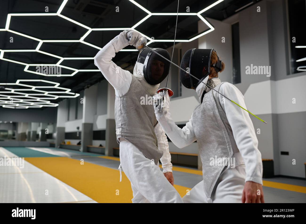 Two fencers crossed swords before fight, closeup shot of fencing dual ...