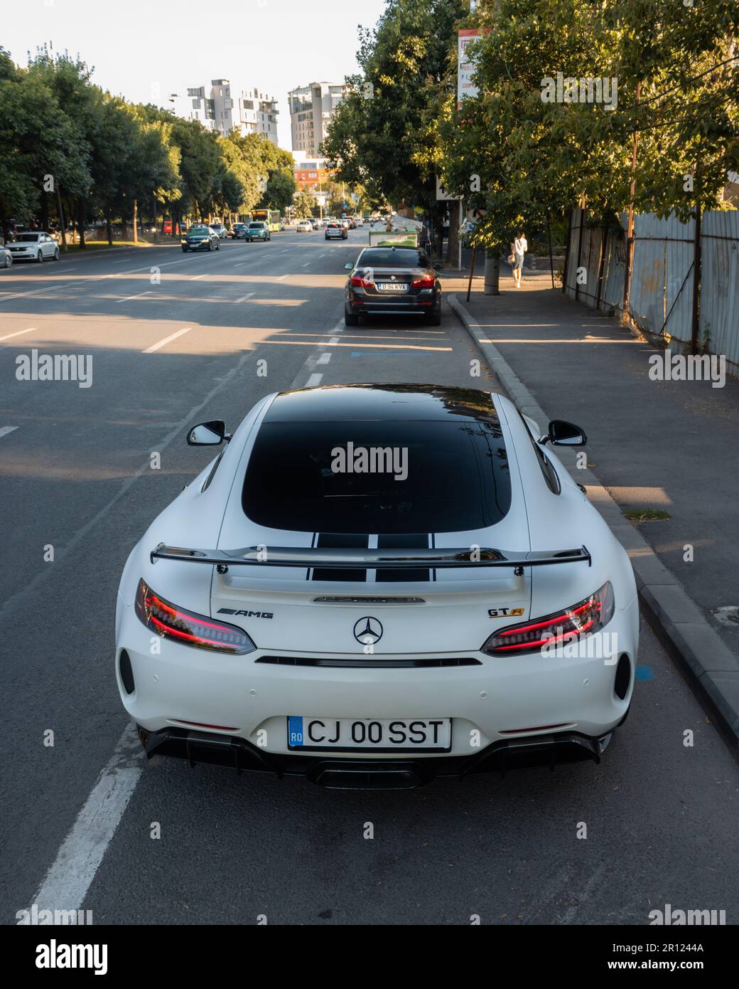 An automobile seen parked on the side of a paved road with a visible ...